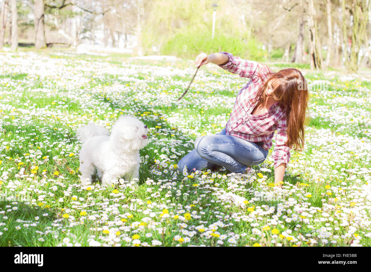 Happy beautiful young woman, enjoying nature with her dog, at sunny ...