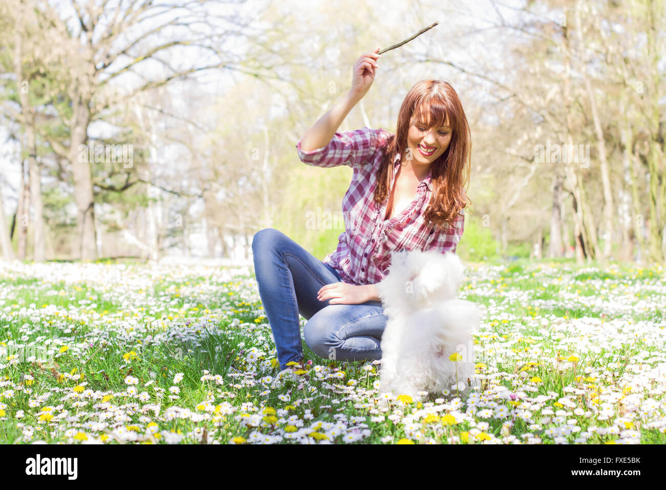 Happy beautiful young woman, enjoying nature with her dog, at sunny ...