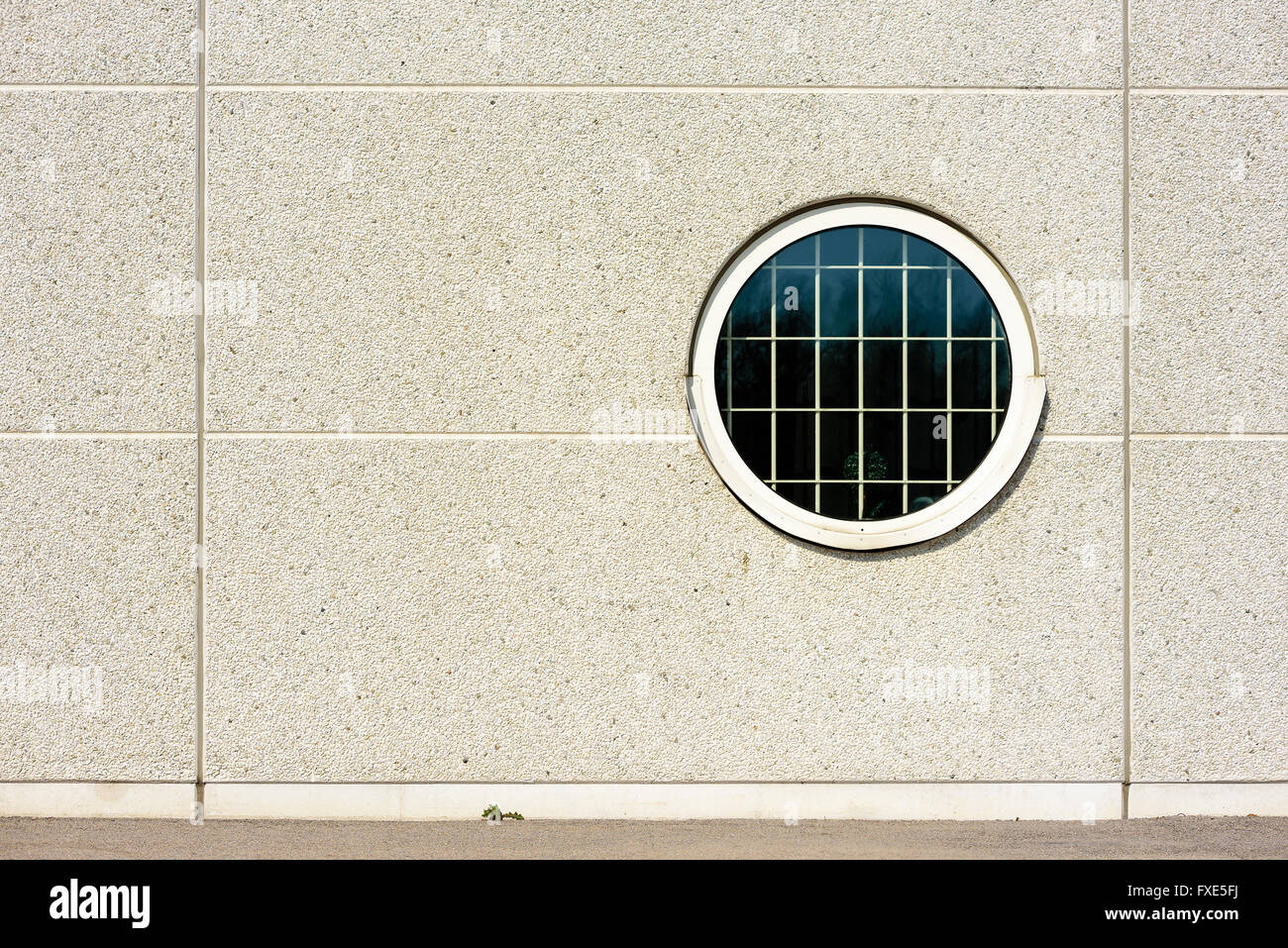Circular window with metal bars on the inside, Copy space on facade ...