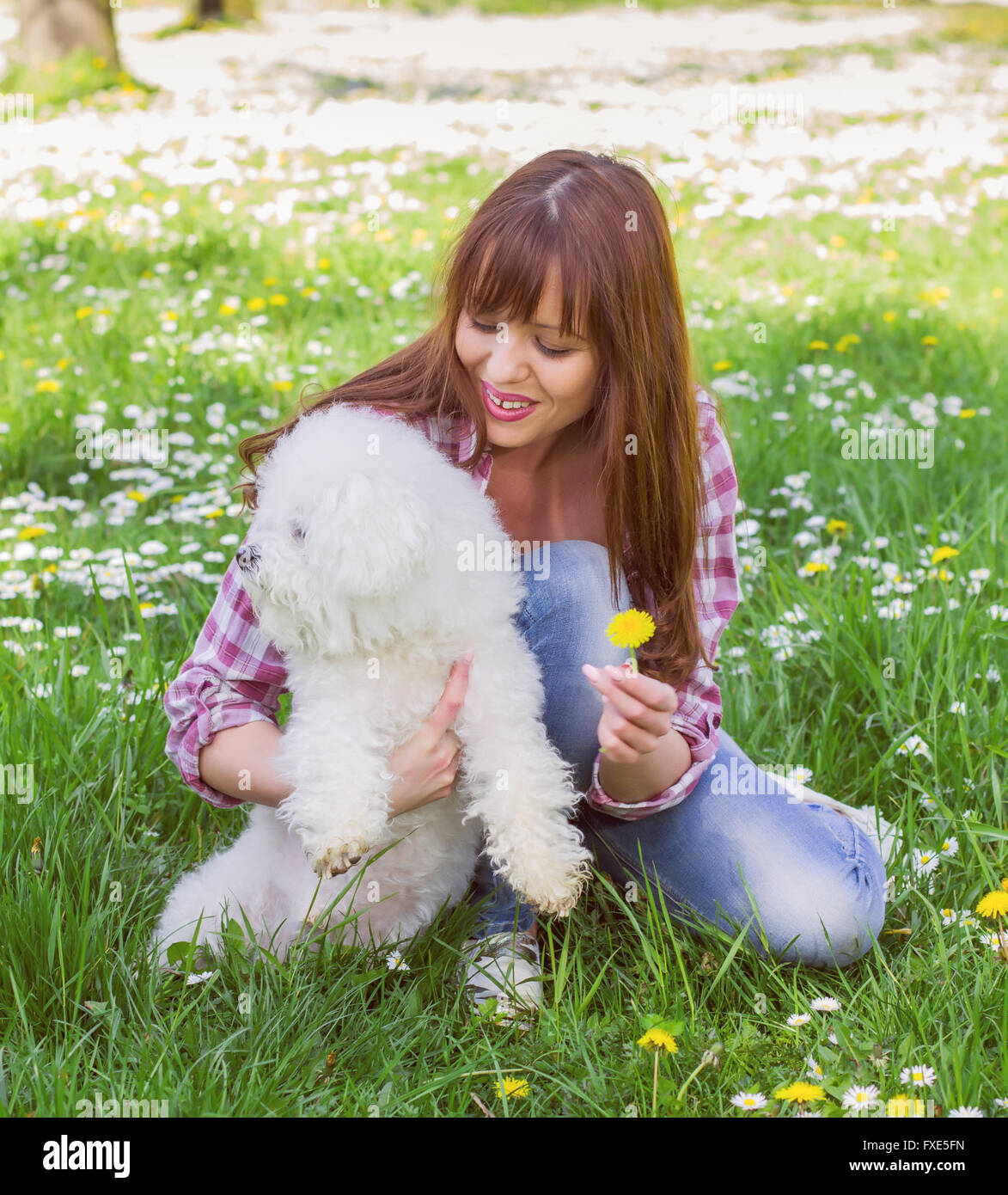 Happy beautiful young woman, enjoying nature with her dog, at sunny ...