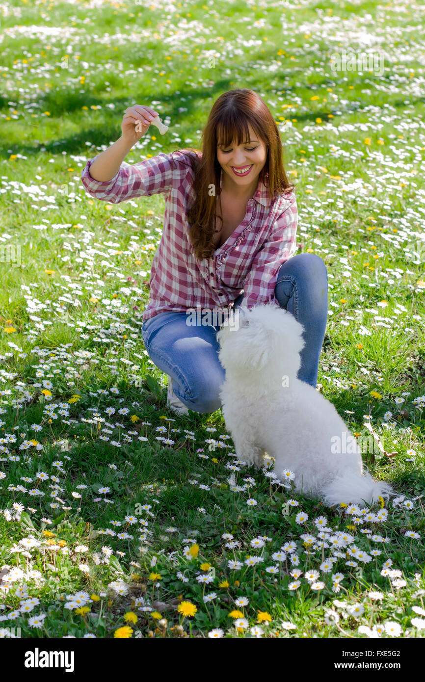Happy beautiful young woman, enjoying nature with her dog, at sunny ...