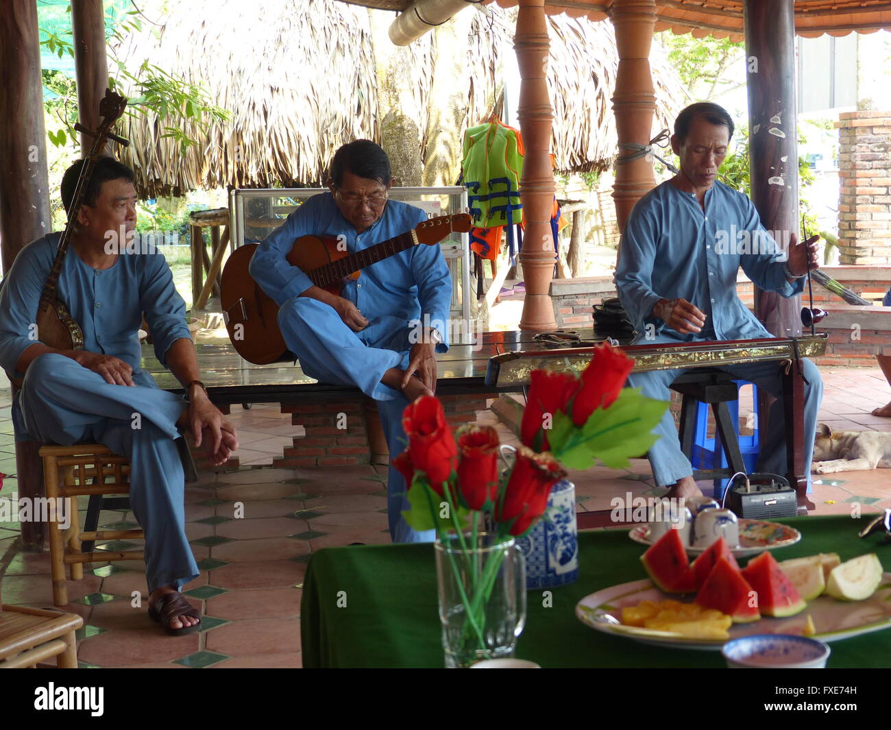 Vietnam, Mekong River Delta, local band members dressed in traditional ...