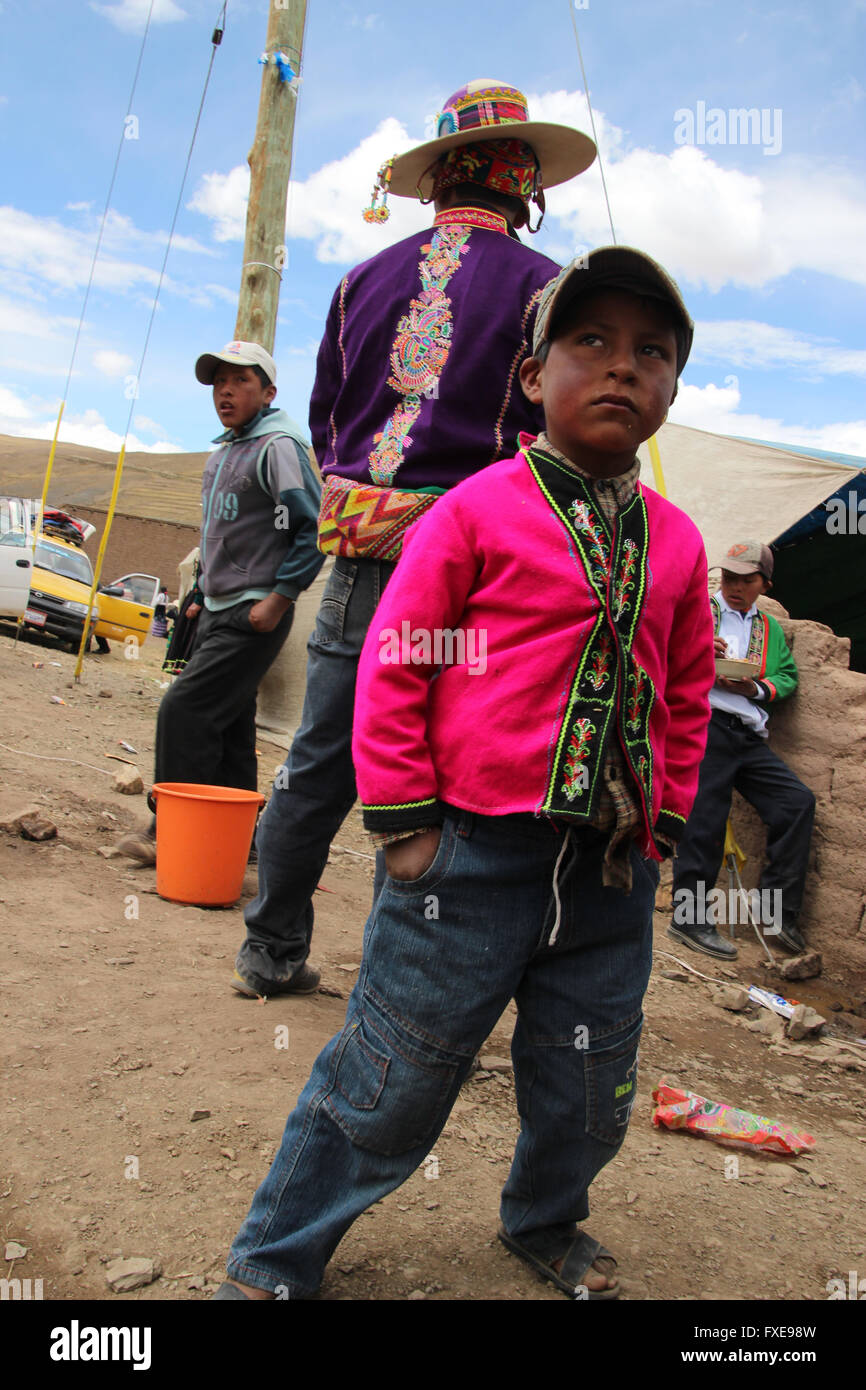 Bolivia, boys and men outside their house Stock Photo - Alamy