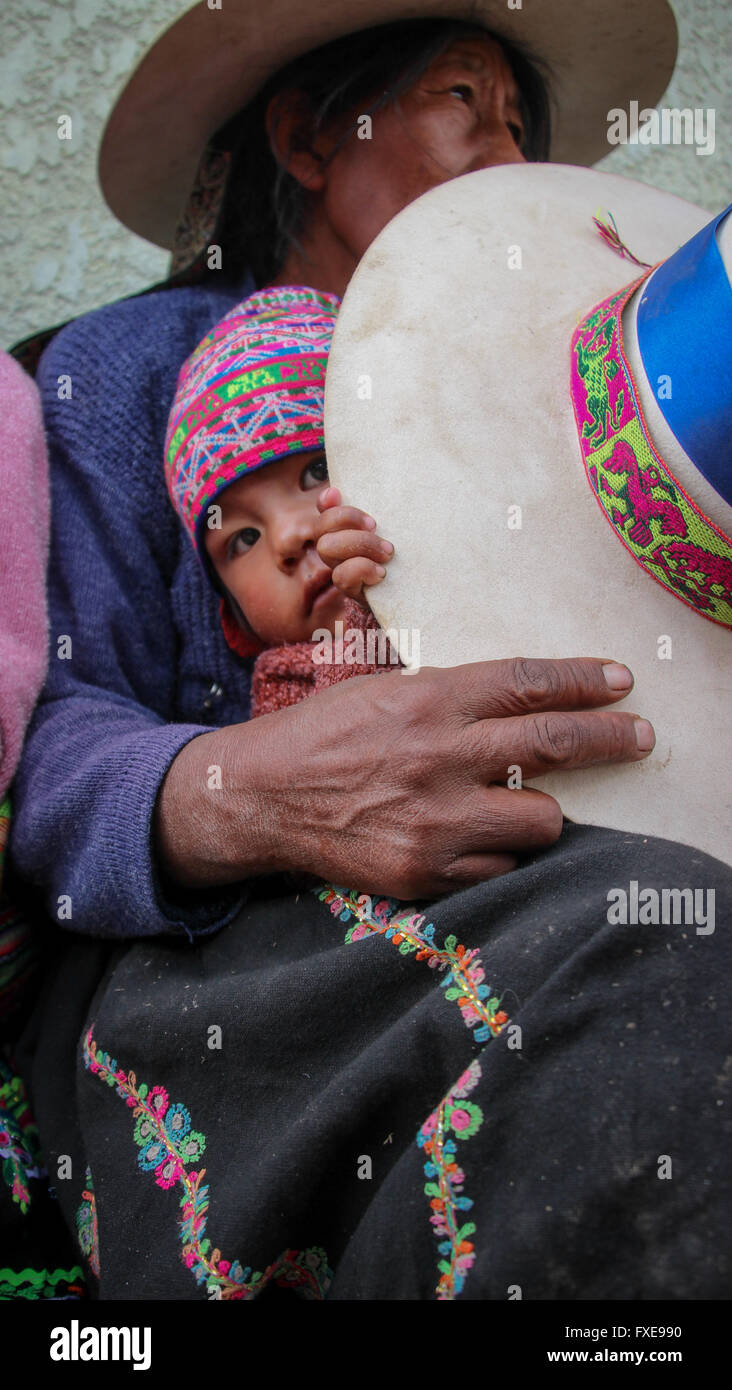 bolivia, child hiding behind father's hat at local village festival ...