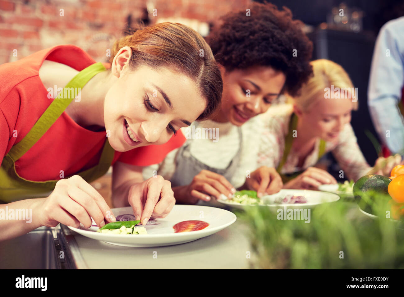 happy women cooking and decorating dishes Stock Photo - Alamy