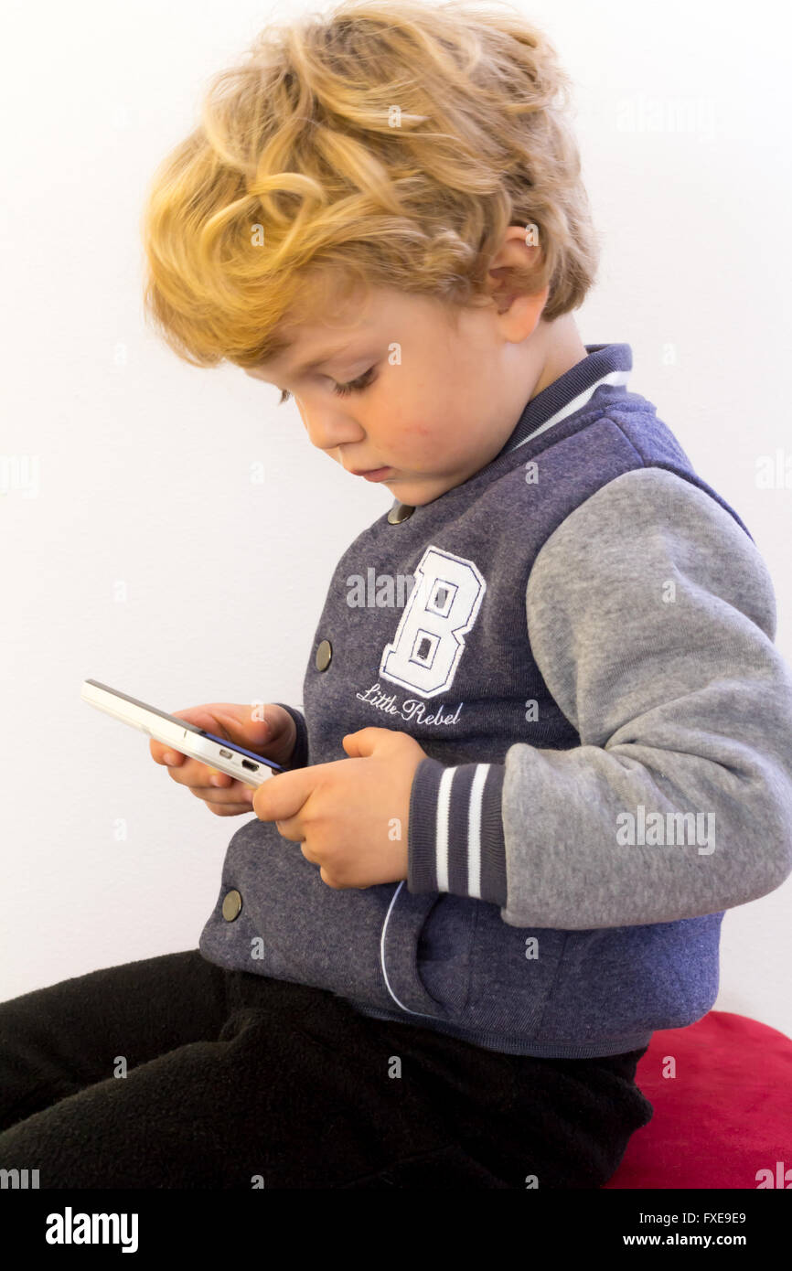 Boy playing a game on a tablet computer Stock Photo - Alamy