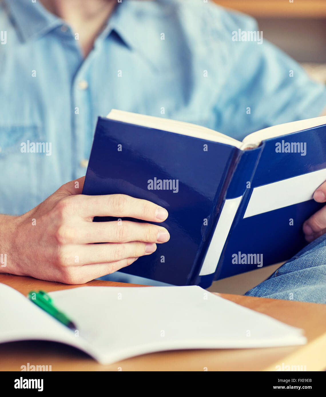 close up of student reading book at school Stock Photo - Alamy