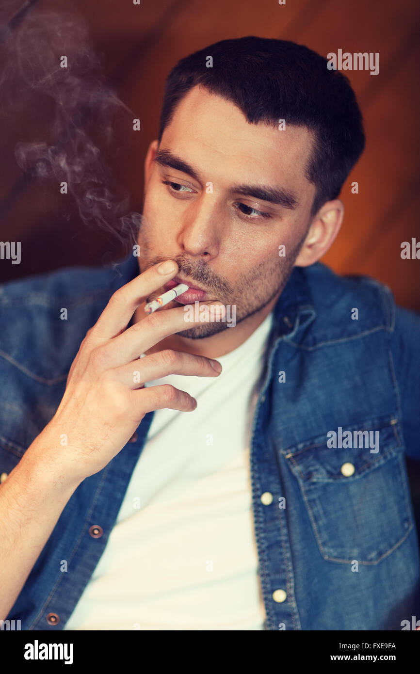 young man smoking cigarette at bar Stock Photo - Alamy