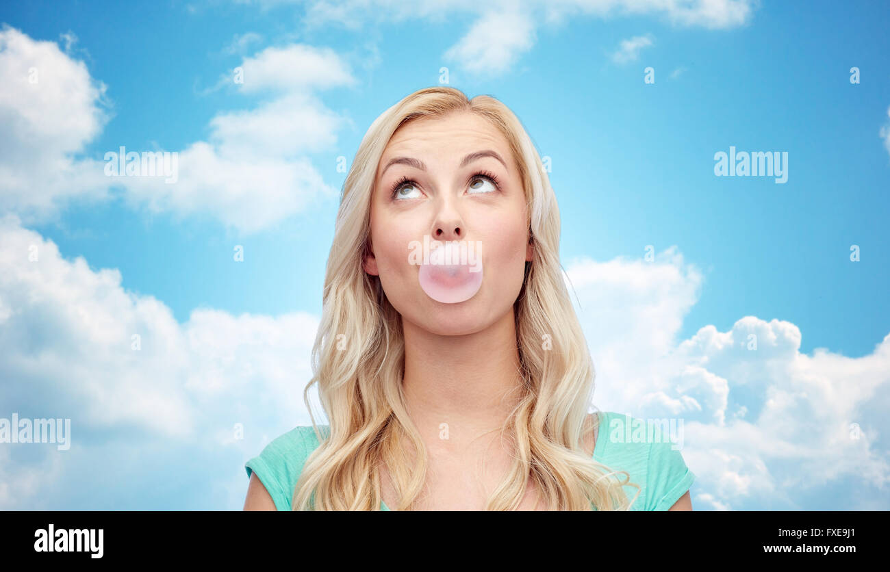 happy young woman or teenage girl chewing gum Stock Photo - Alamy