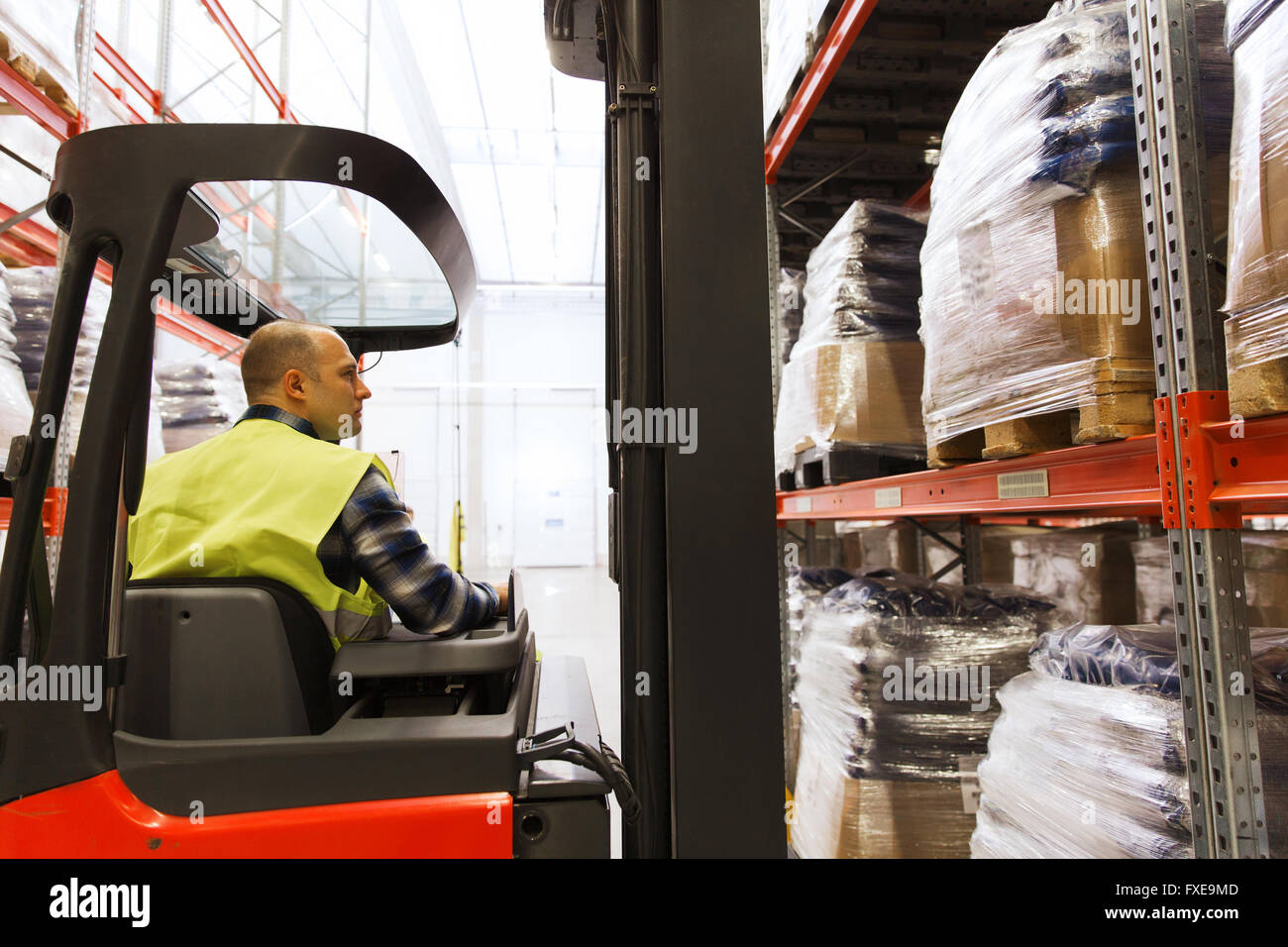 man operating forklift loader at warehouse Stock Photo - Alamy