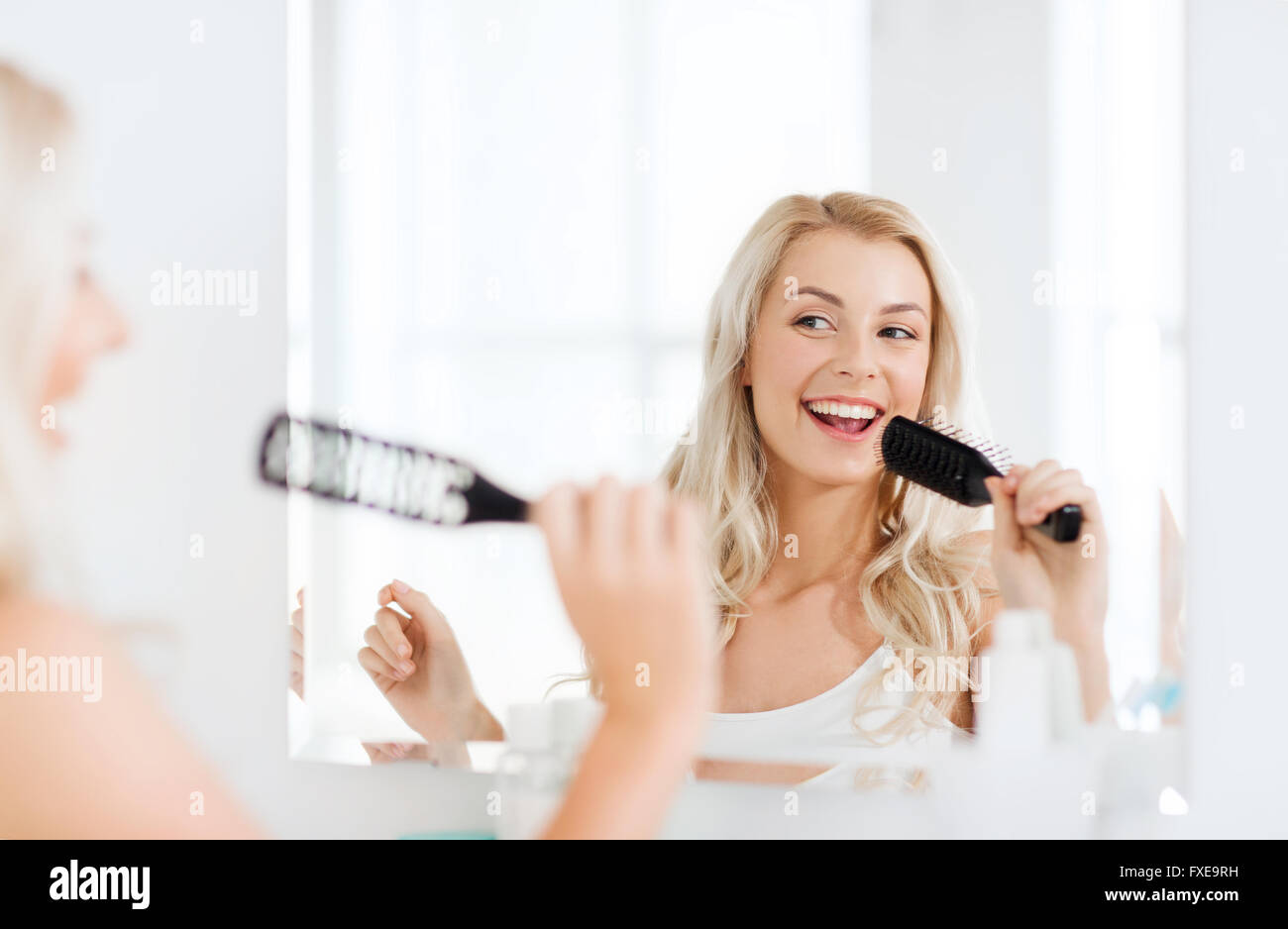 happy woman singing to hair brush at bathroom Stock Photo - Alamy