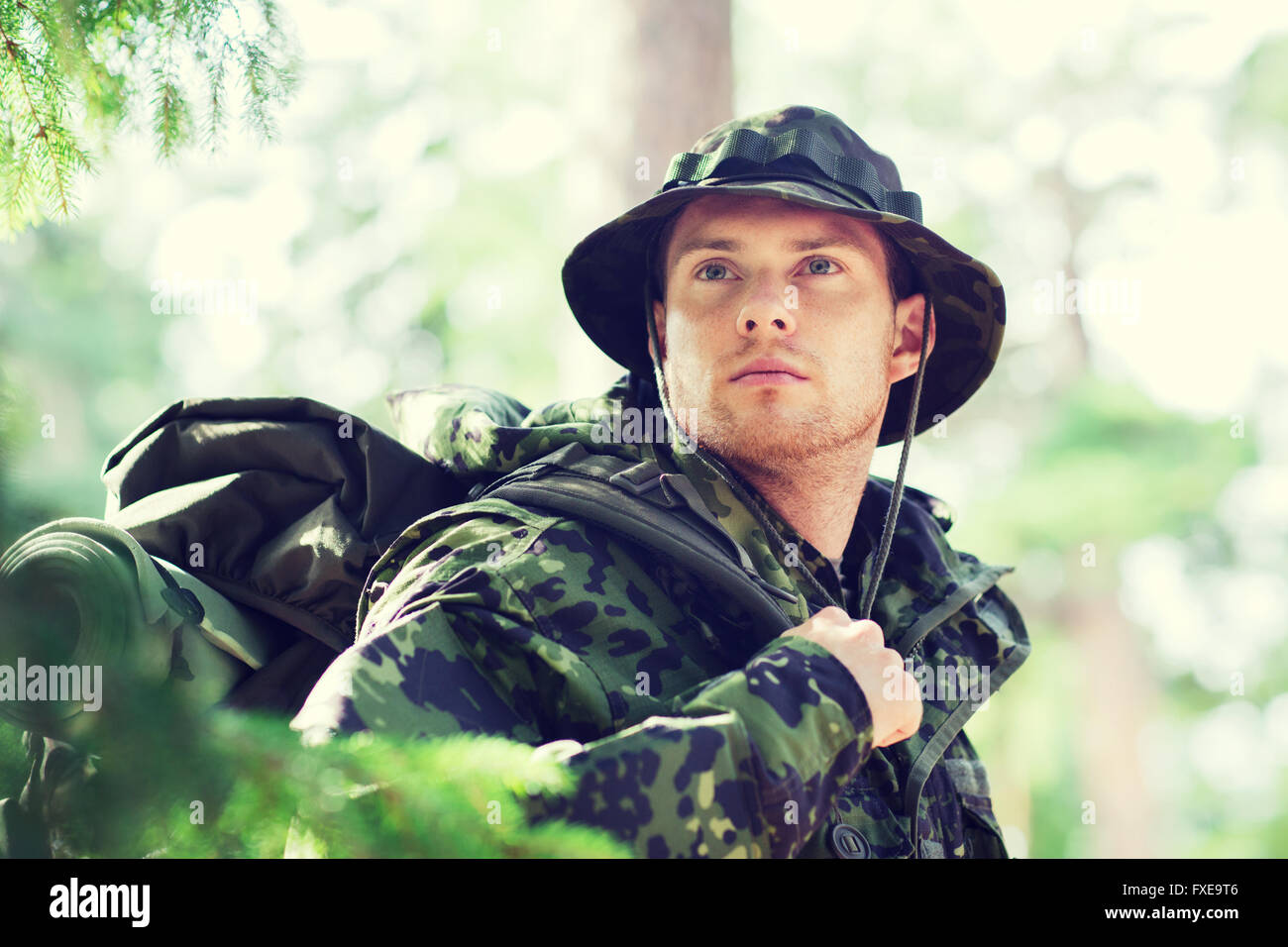 young soldier with backpack in forest Stock Photo - Alamy