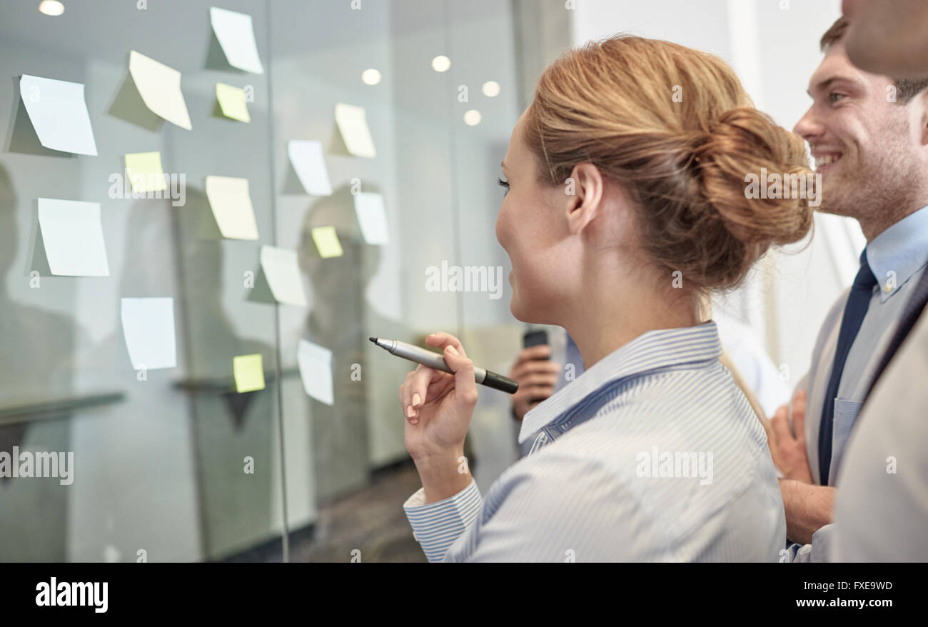 smiling business people with marker and stickers Stock Photo - Alamy