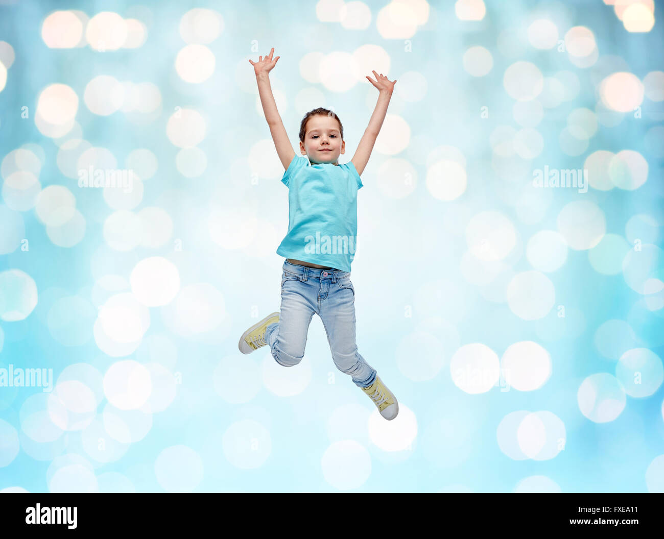 happy little girl jumping in air over blue lights Stock Photo - Alamy