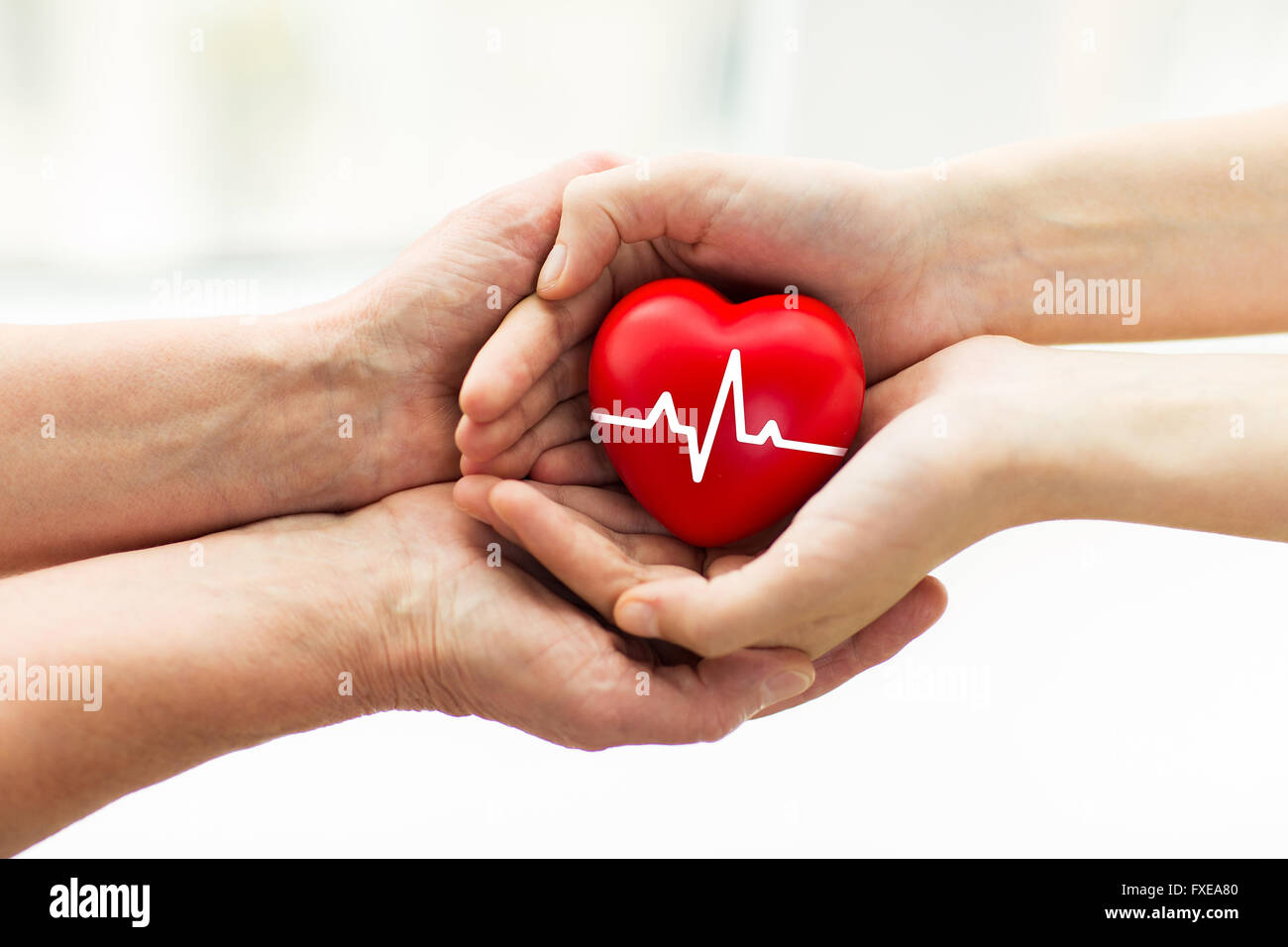 man hand giving red heart to woman Stock Photo - Alamy