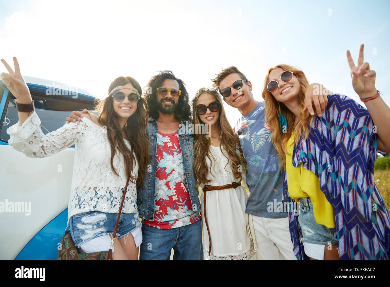 hippie friends over minivan car showing peace sign Stock Photo - Alamy