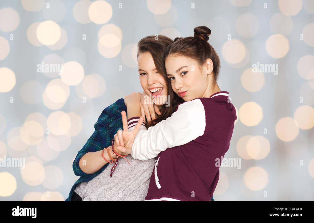 happy teenage girls hugging and showing peace sign Stock Photo - Alamy