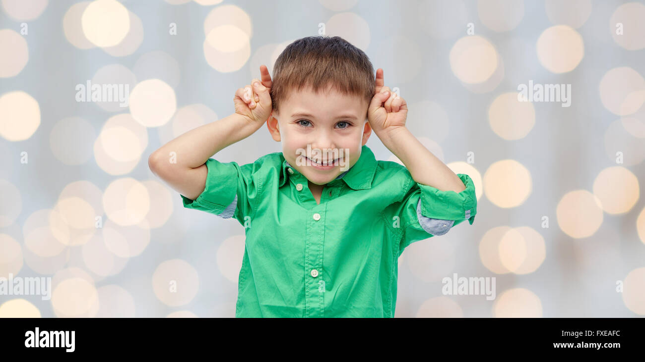 happy little boy having fun and making horns Stock Photo - Alamy