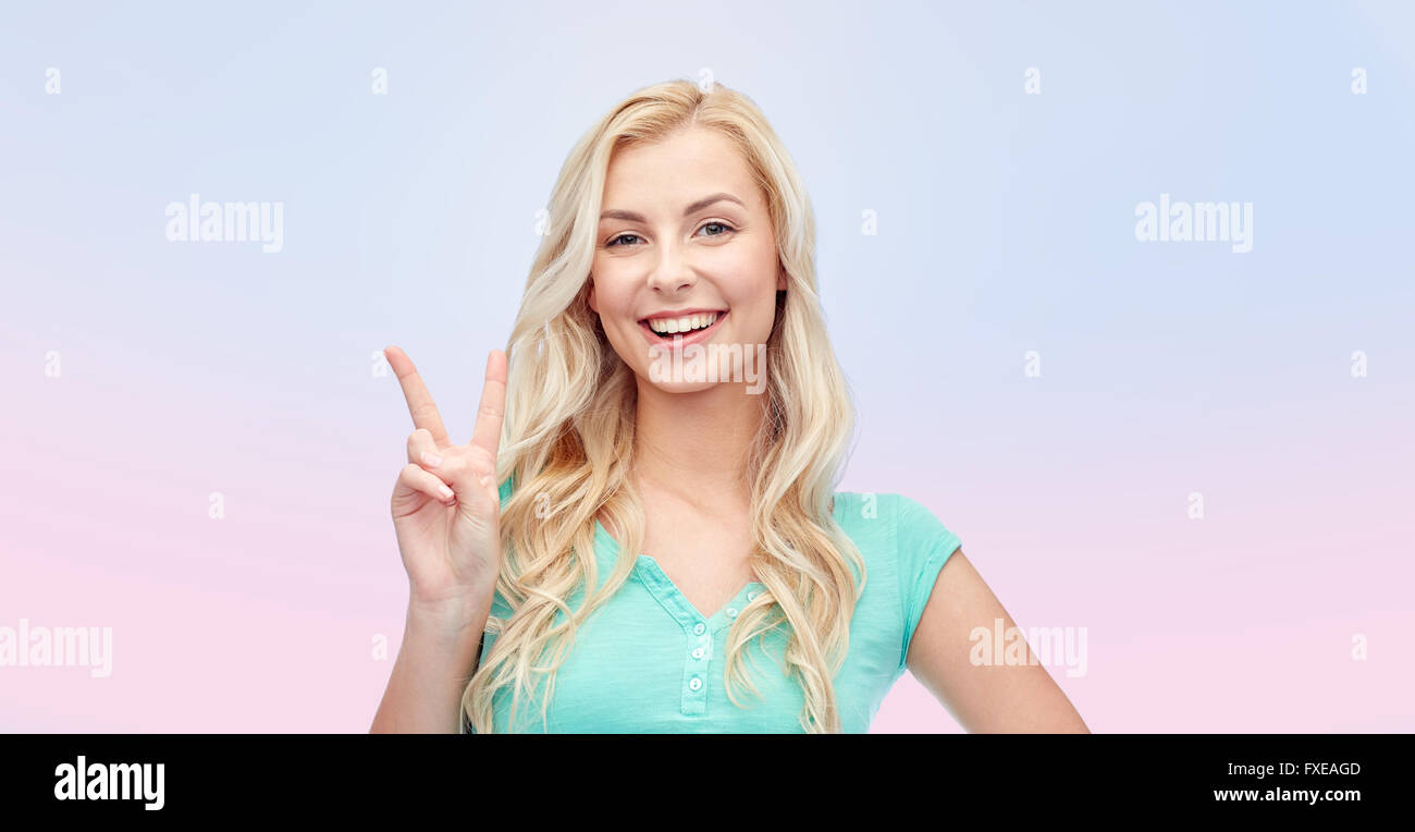 smiling young woman or teenage girl showing peace Stock Photo - Alamy