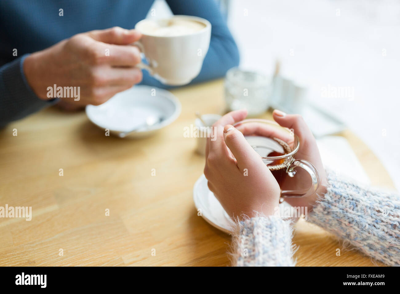 close up of couple drinking tea at cafe Stock Photo - Alamy