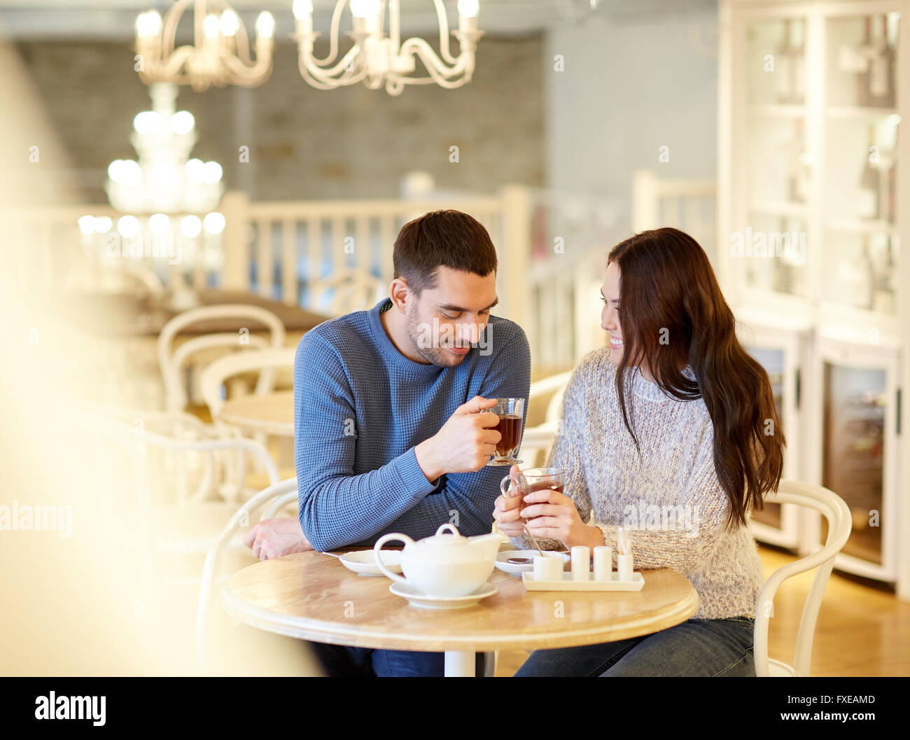 happy couple drinking tea at cafe Stock Photo - Alamy