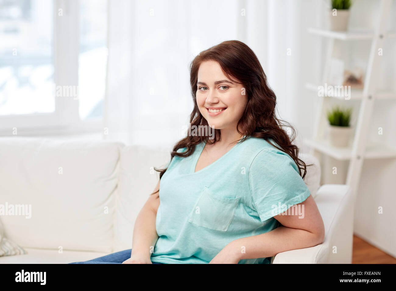 happy young plus size woman at home Stock Photo - Alamy