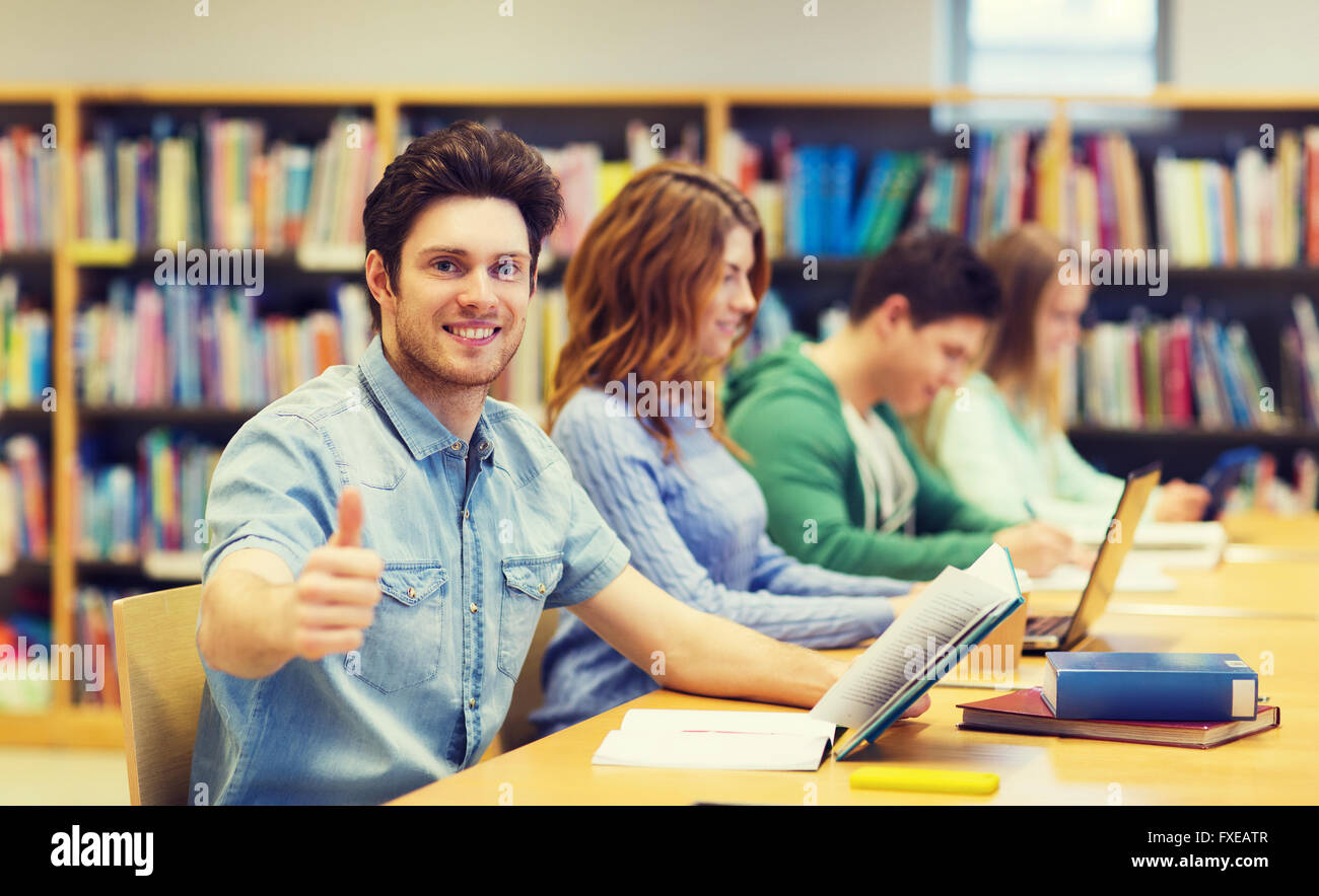 happy student boy preparing to exam in library Stock Photo - Alamy