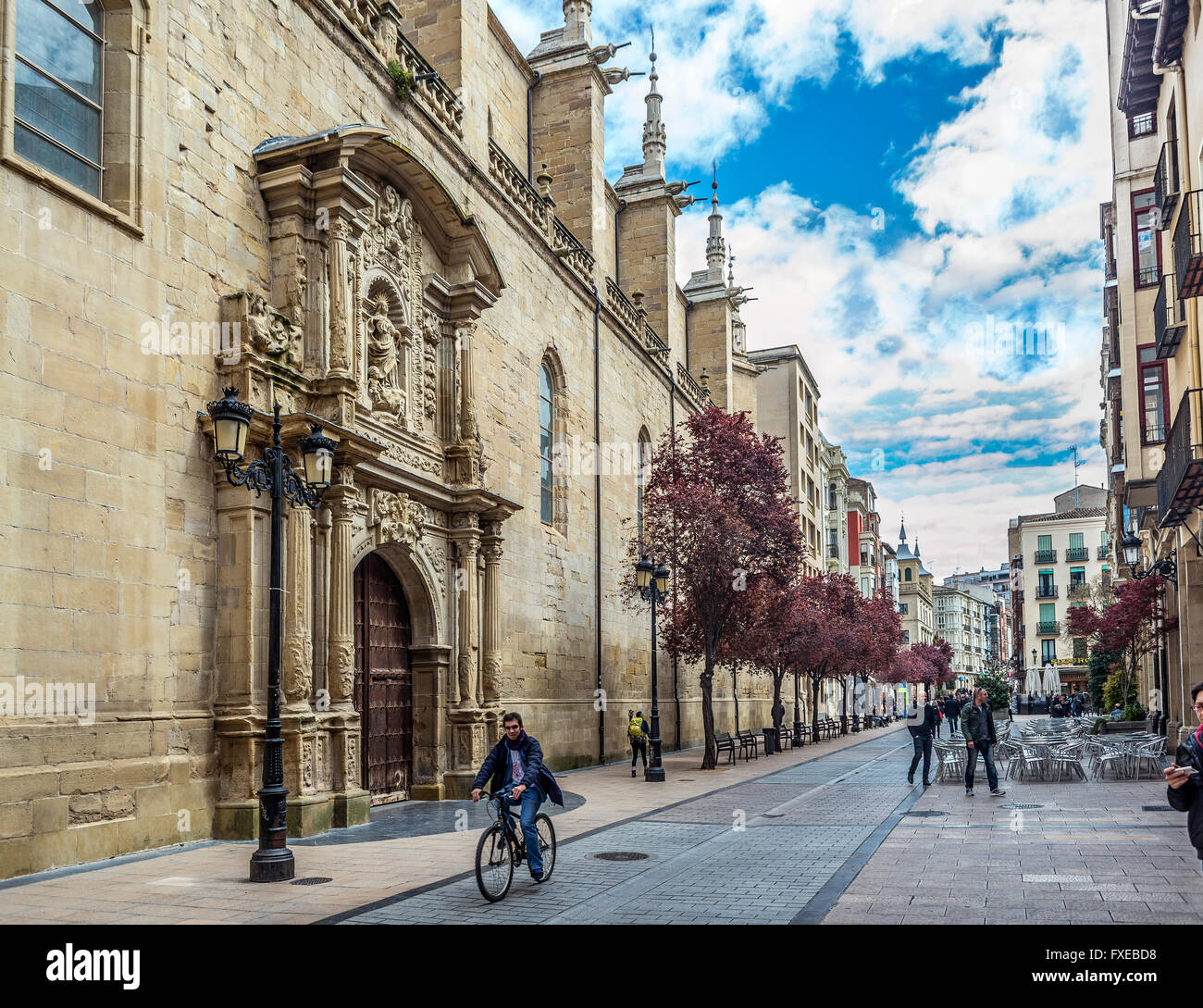 Men in bike rolling in front of lateral facade of Concatedral de Santa Maria de la Redonda ...