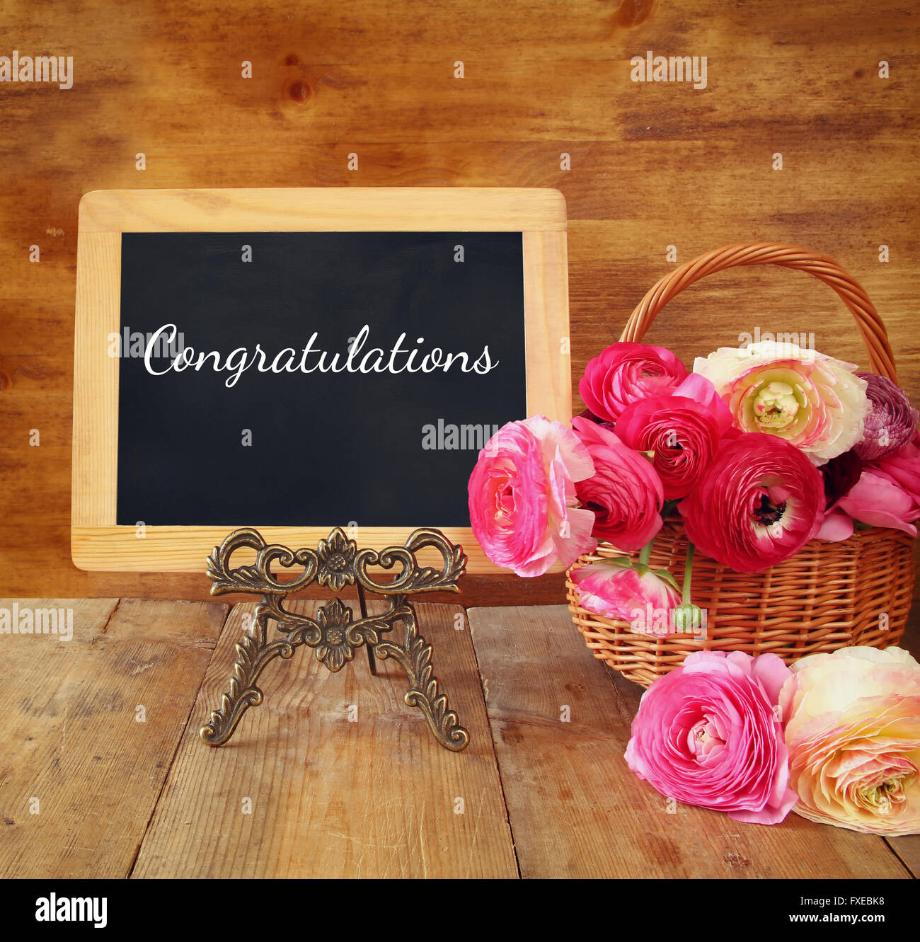 pink flowers next to blackboard with phrase: congratulations, on wooden ...