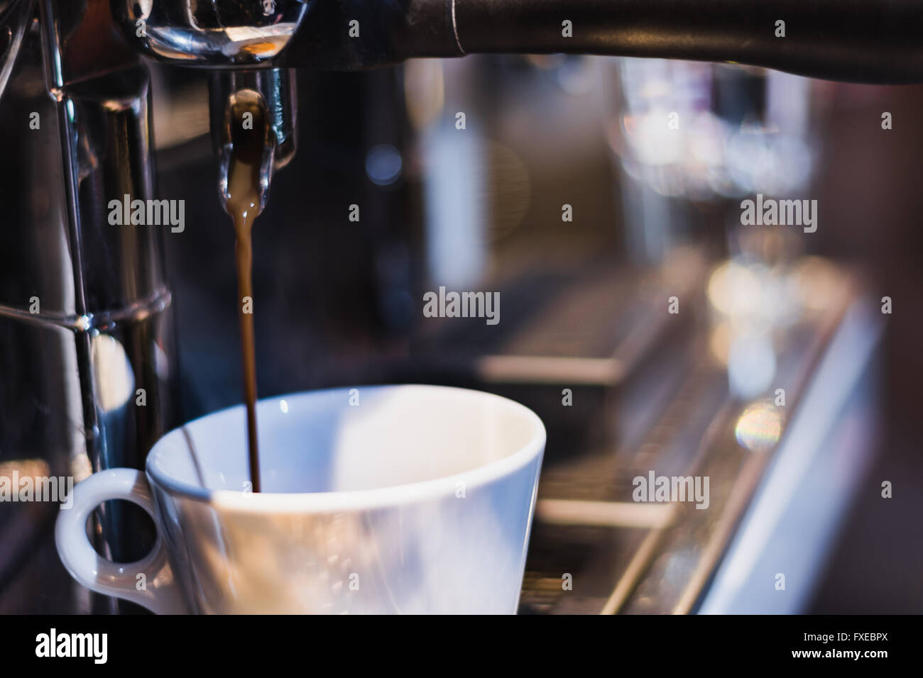 coffee machine pouring coffee into a white mug Stock Photo - Alamy