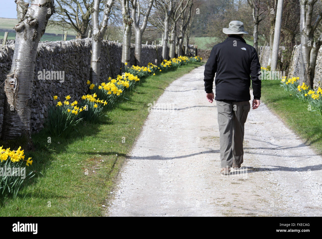 Walker on a public footpath which passes through a farm in the Peak ...