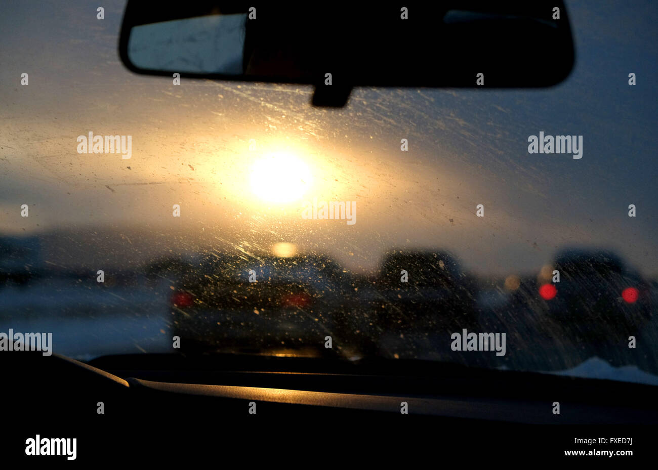 Atmospheric view through a car windshield looking onto traffic and a ...