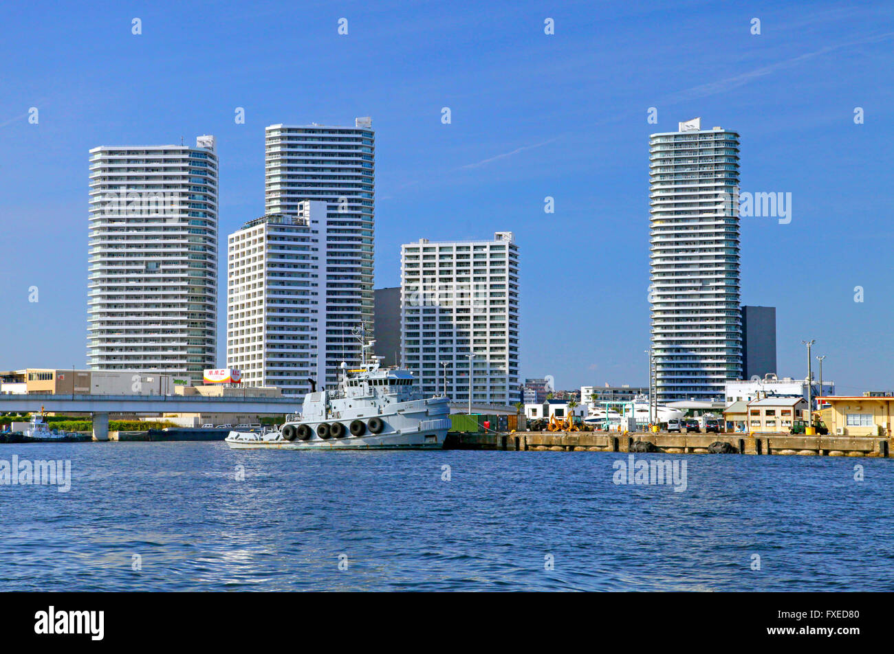 US Army tugboat at Port of Yokohama Cotton Harbor Towers background ...