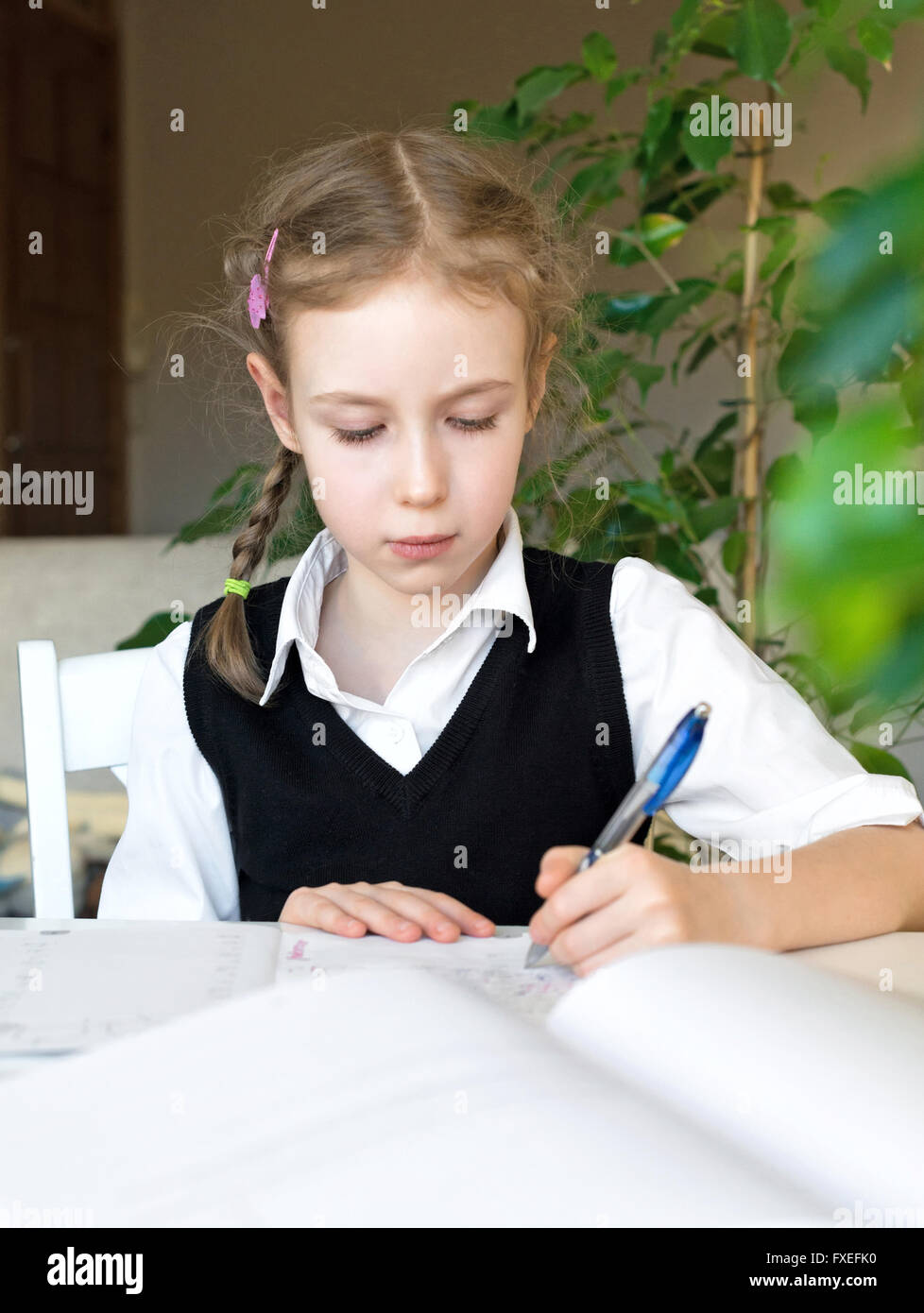 Little girl doing her homework at home Stock Photo - Alamy