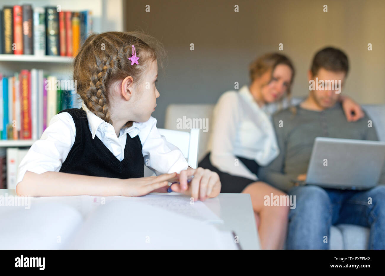 Little girl asking for help but parents ignoring her Stock Photo - Alamy