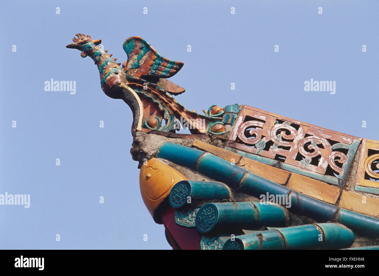 China, Hunan, Yueyang Temple, carved bird statuette on eave of the ...