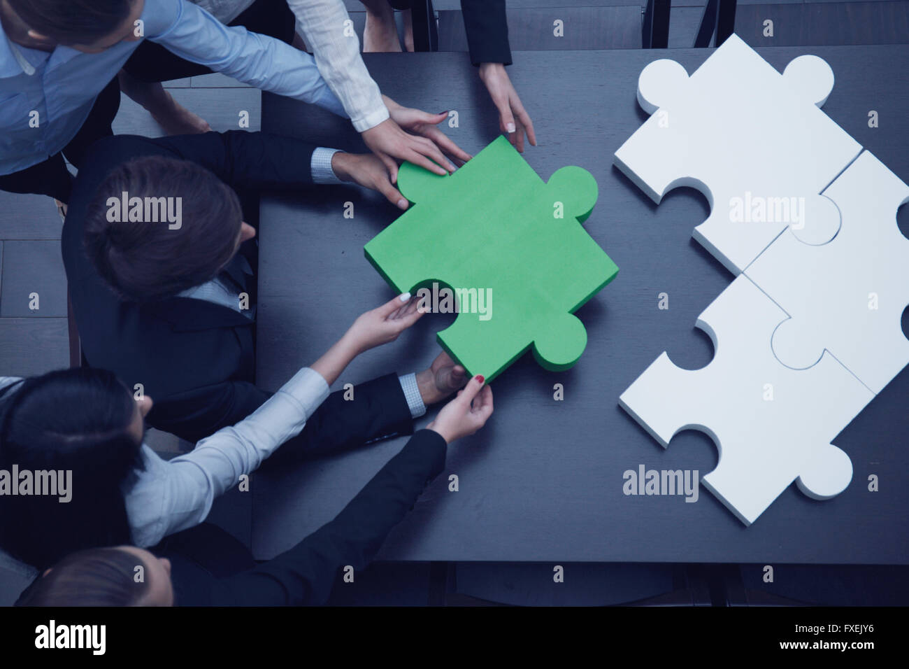 Group of business people assembling jigsaw puzzle, team support and ...