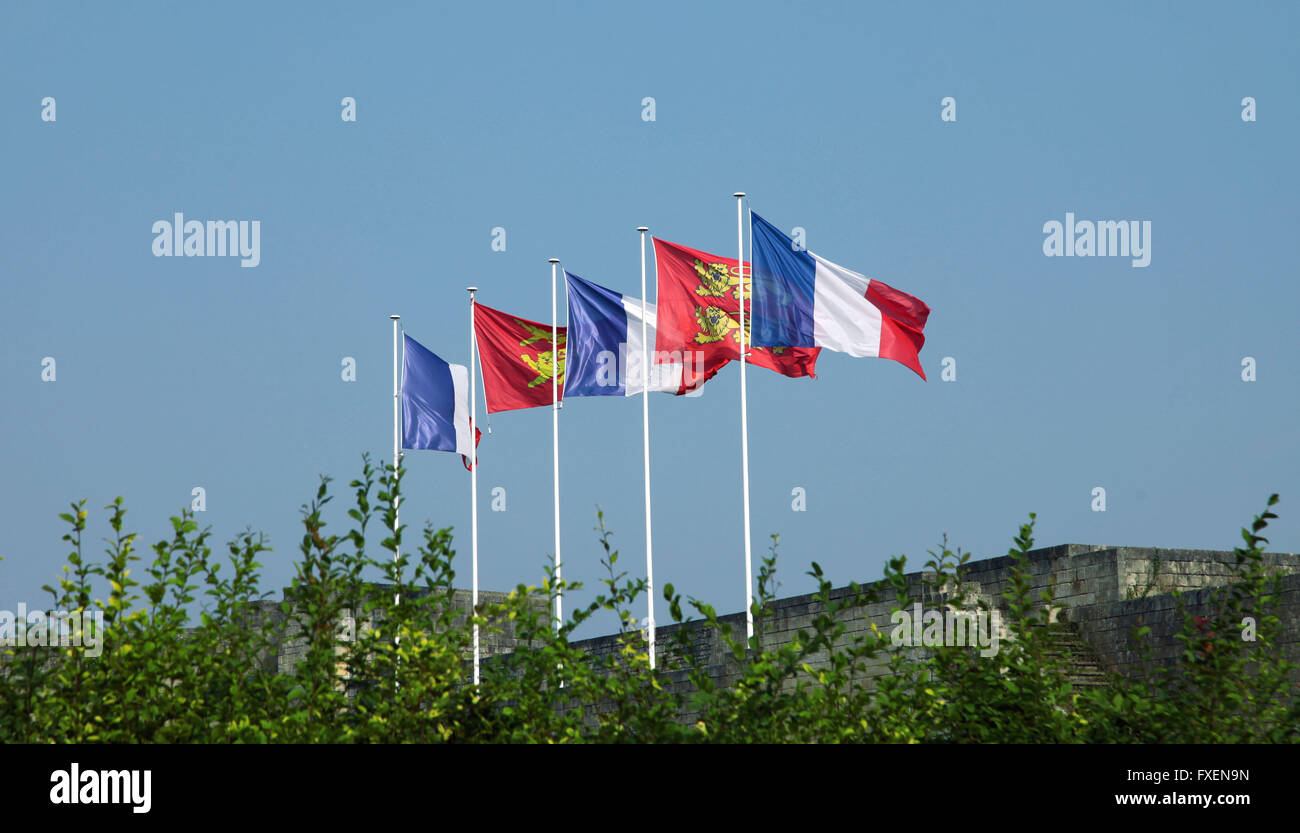 It's a photo of 5 flags side by side on Masts. They are floating in the ...
