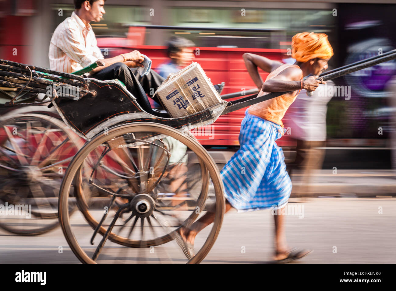 Panning photography image of a man pulling a hand drawn rickshaw on the ...