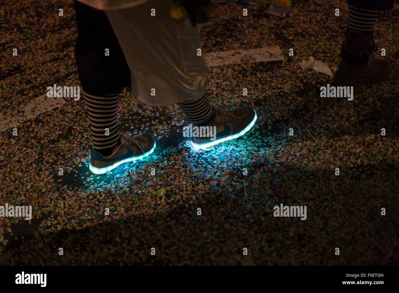 View on neon glowing shoes worn by a Basel carnival participant. The ...