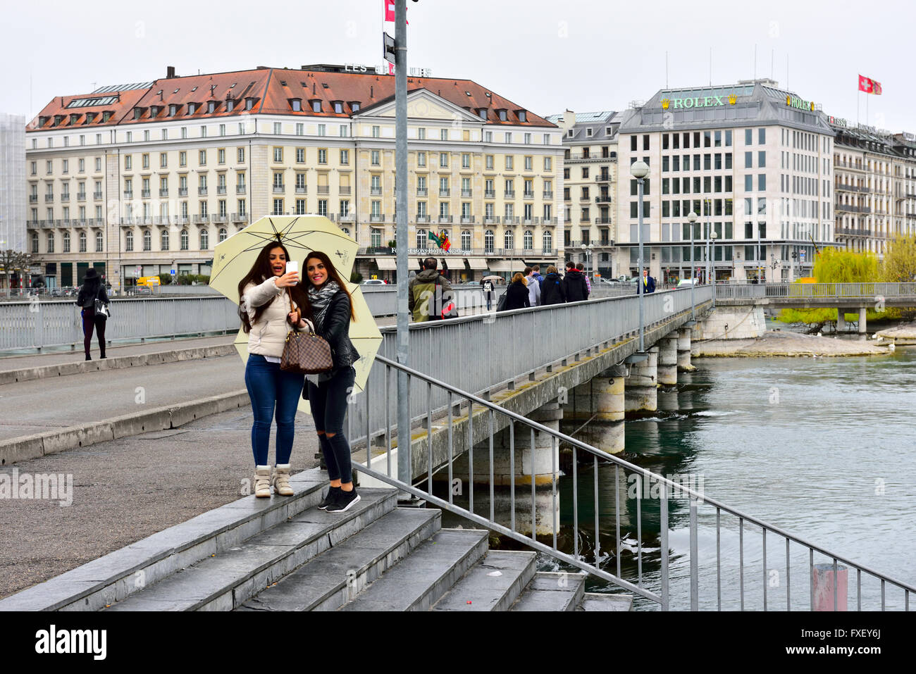 Rain doesn't deter umbrella holding tourists on Pont des Bergues bridge ...