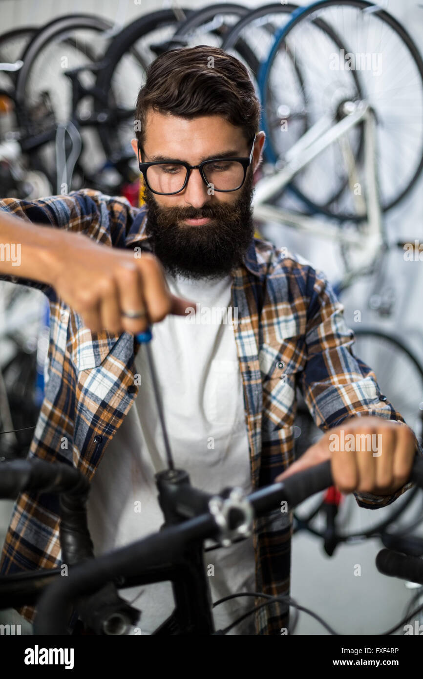 Bike mechanic checking at bicycle Stock Photo - Alamy
