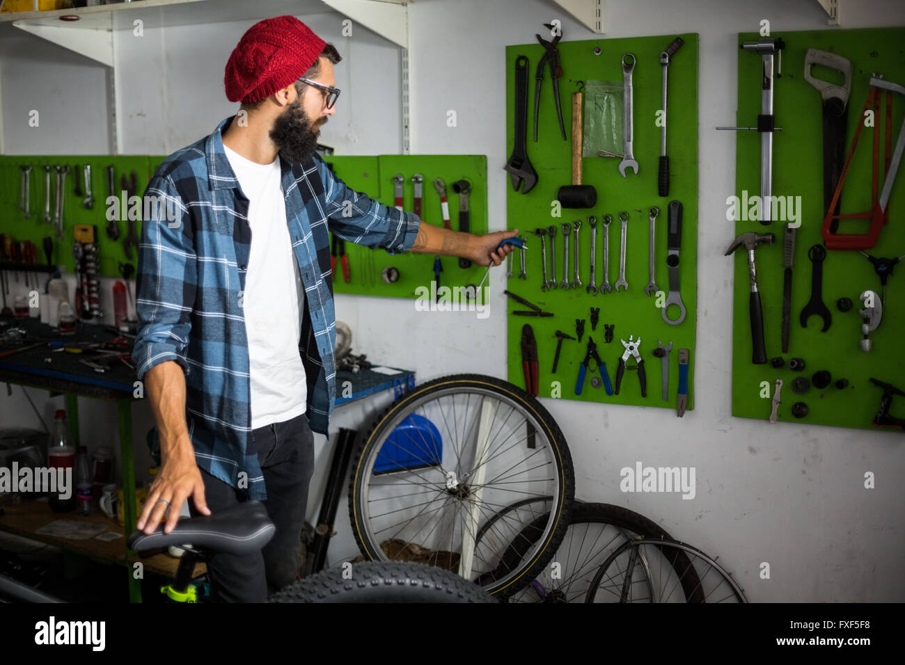 Bike mechanic picking up tools to repair a bicycle Stock Photo - Alamy