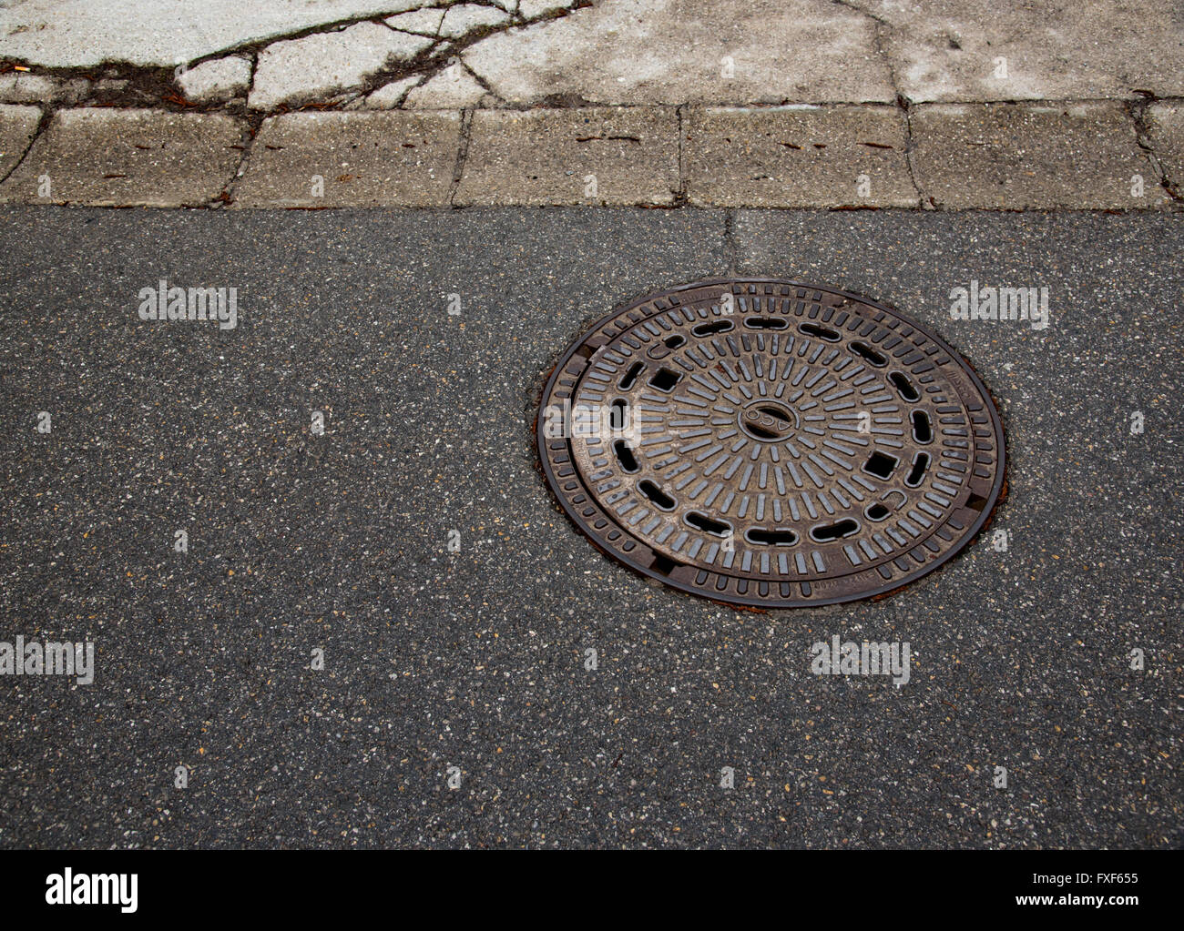 Abstract manhole cover on asphalt Stock Photo - Alamy