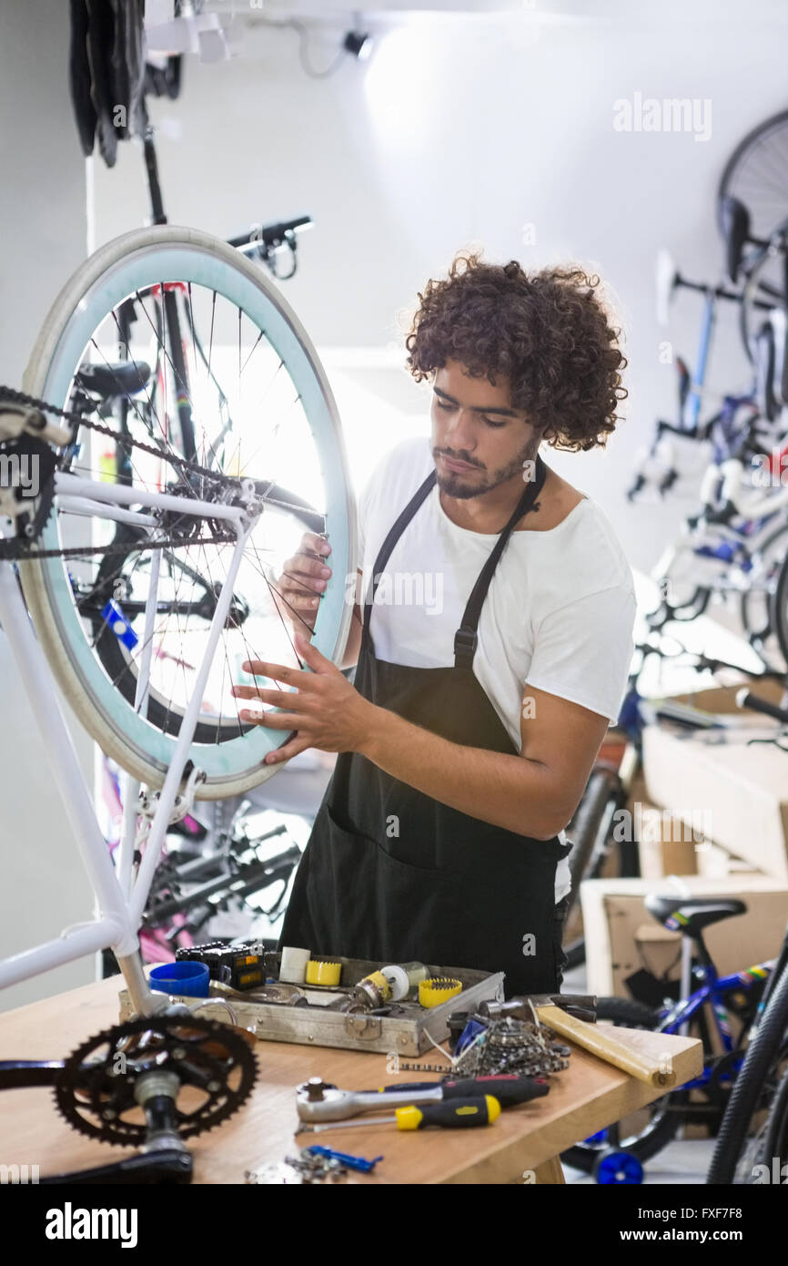 Worker repairing bicycles Stock Photo - Alamy