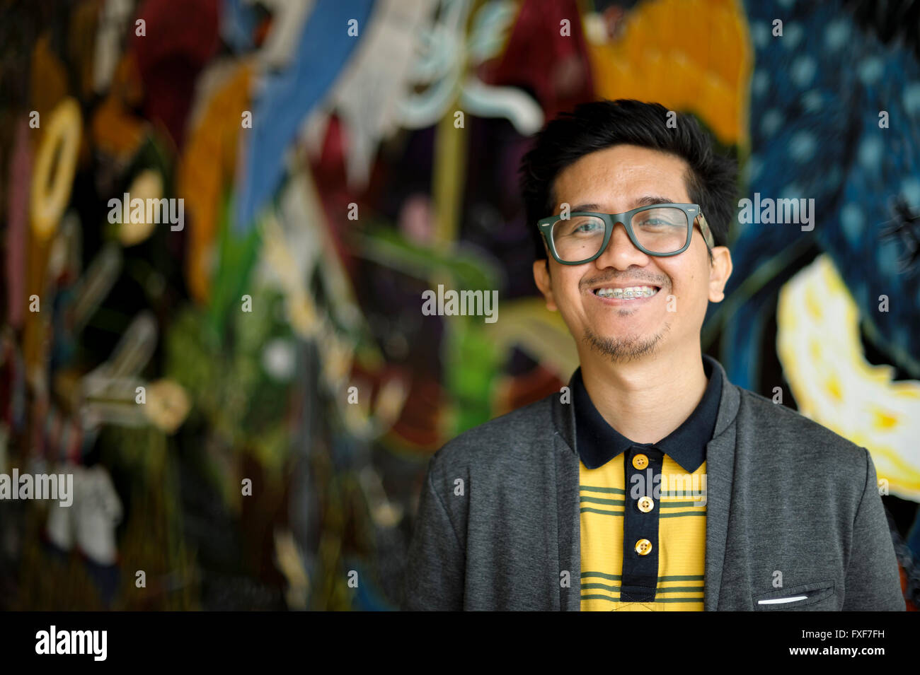 Philippine artist Rodel Tapaya poses with his artwork at the Art ...