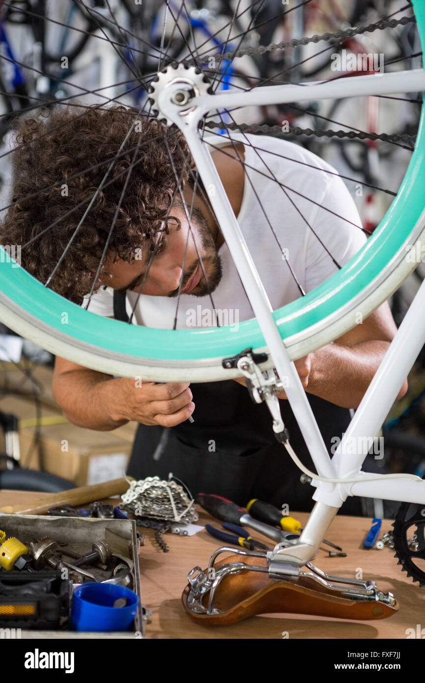 Worker repairing bicycles Stock Photo - Alamy