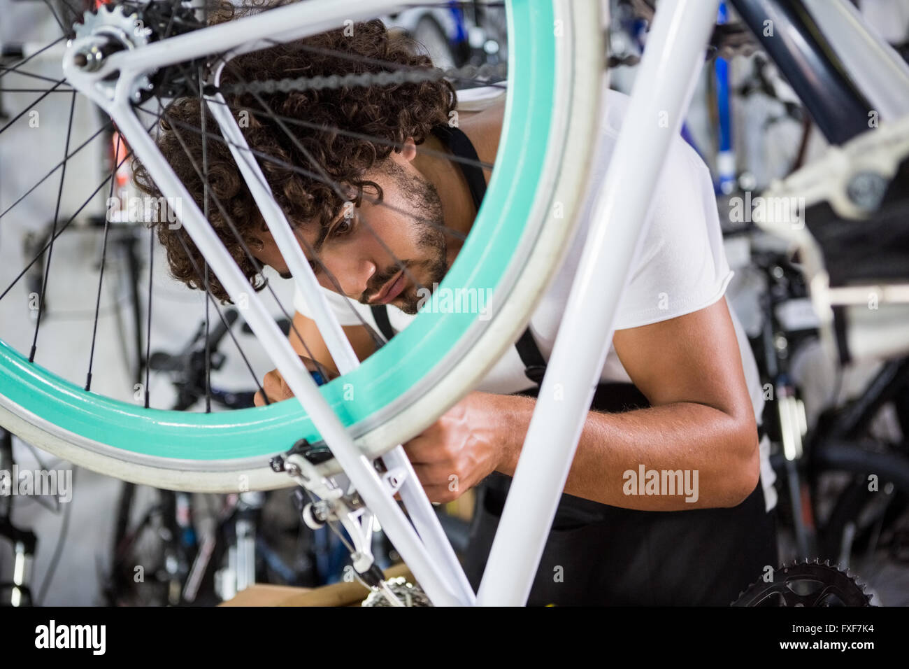 Worker repairing bicycles Stock Photo - Alamy