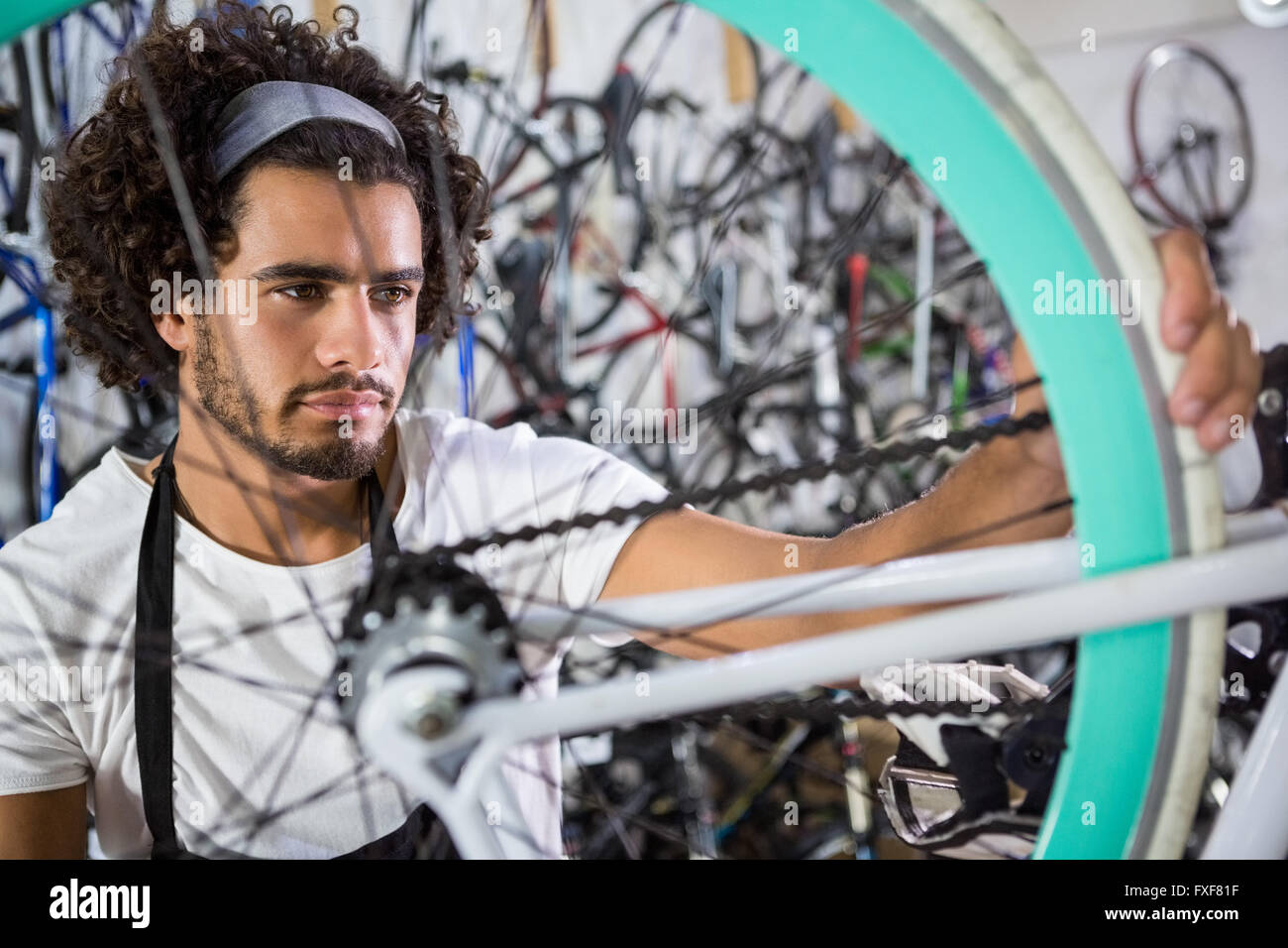 Worker repairing bicycles Stock Photo - Alamy