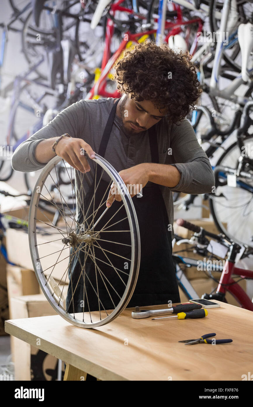 Worker repairing bicycles Stock Photo - Alamy